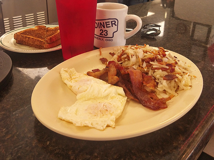 Breakfast perfection on a plate: eggs cooked exactly as ordered, bacon with that ideal crispy-chewy balance, and hash browns worth fighting over.