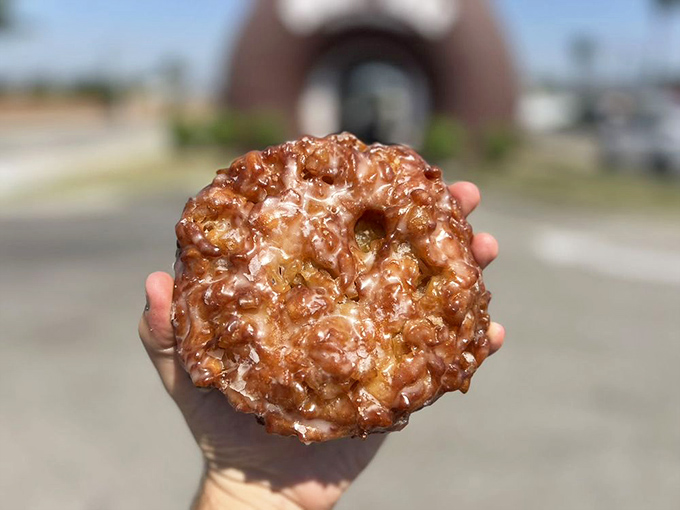 This apple fritter isn't just breakfast&mdash;it's edible architecture, a caramelized cathedral of cinnamon-spiced apple chunks that shatters gloriously with each bite.