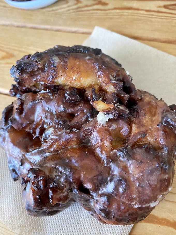 This apple fritter isn't just a pastry, it's architecture &ndash; a caramelized cathedral of apple-cinnamon glory that demands reverence.