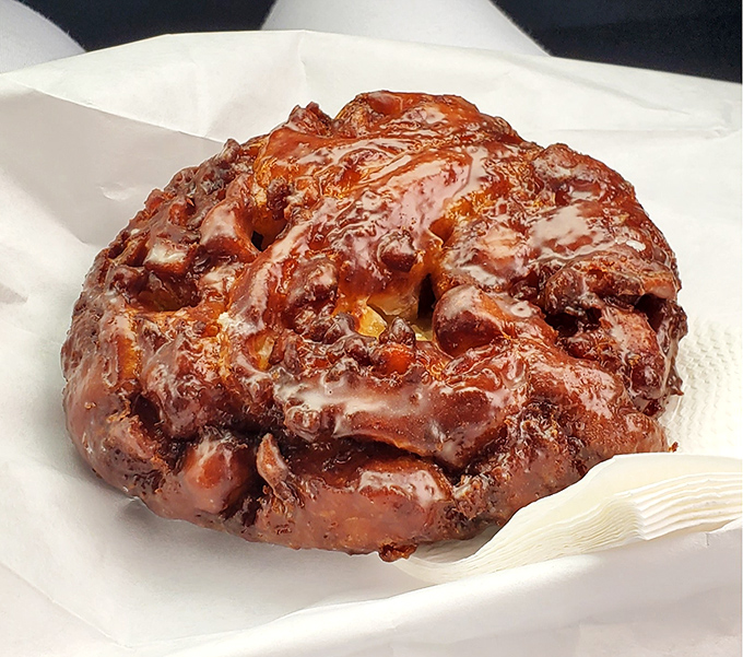 This apple fritter isn't just a pastry, it's a topographical marvel of caramelized peaks and valleys that would make the Grand Canyon jealous.