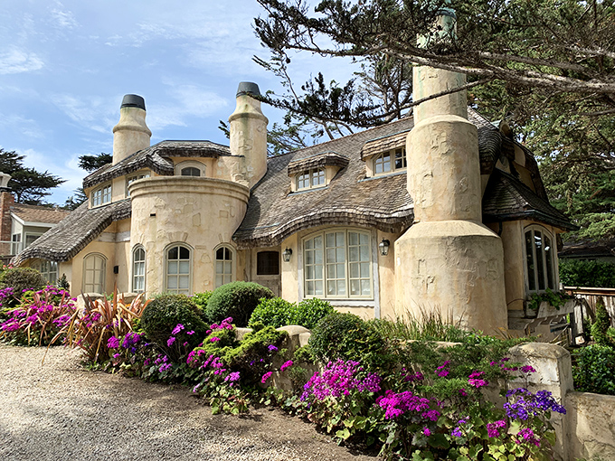 Fairy tales aren't just for books. This storybook cottage with its whimsical chimneys and undulating roofline proves architecture can have a sense of humor.