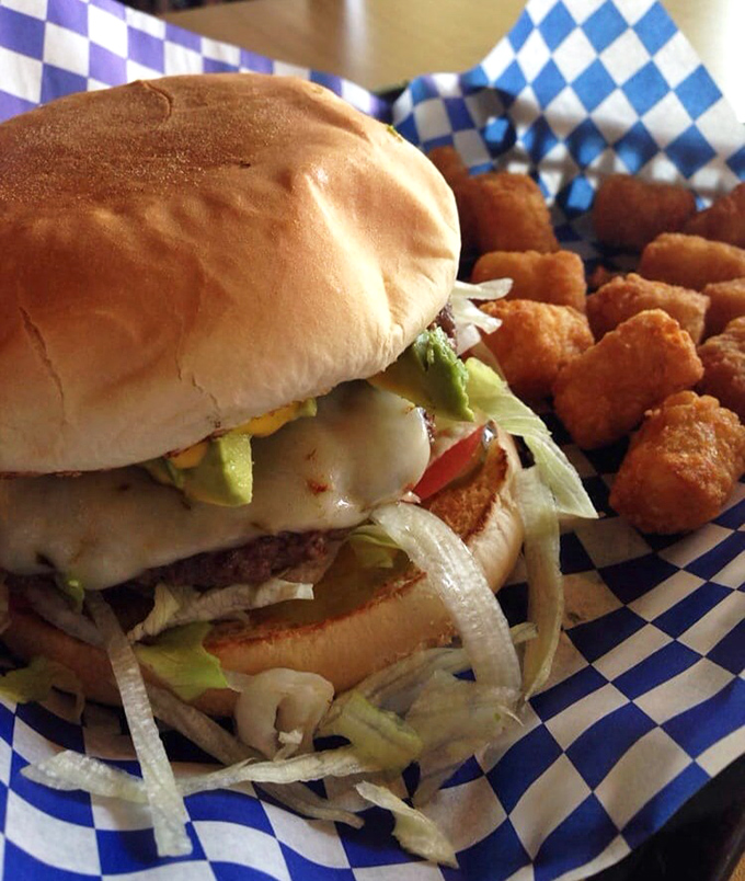 Behold the star of our show: layers of fresh avocado, melted cheese, and a perfectly seasoned patty. Napkins required, regrets impossible.