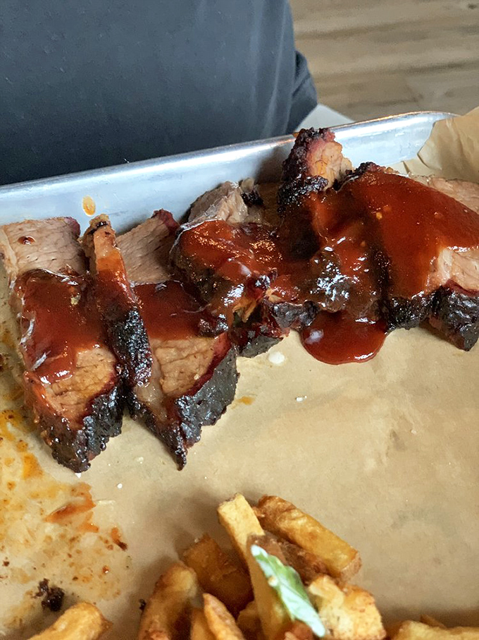 Behold the brisket in all its glory&mdash;that bark, that smoke ring, that sauce. This isn't food; it's edible poetry.