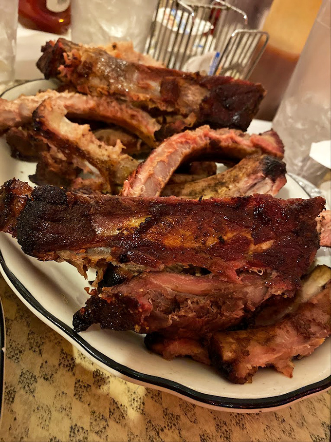 These ribs fall off the bone like autumn leaves, each bite a masterclass in patience and smoke.