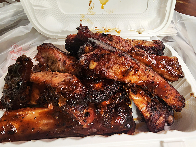 These ribs aren't just cooked; they're transformed – the bark developed with the patience of a meditating monk, the meat surrendering to smoke with dignity.