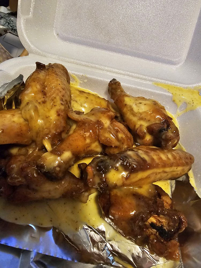 These BBQ wings aren't just cooked, they're transformed. Swimming in that signature sauce with melted cheese, they're the kind of messy perfection that demands extra napkins.