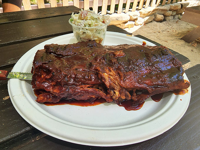 These legendary ribs arrive looking like they've been kissed by smoke and blessed by barbecue gods themselves.