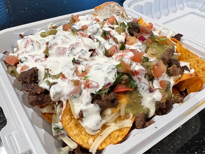 Nachos that laugh in the face of restraint. These barbacoa-topped beauties come loaded with enough cheese, sour cream, and guacamole to require a strategic eating plan.