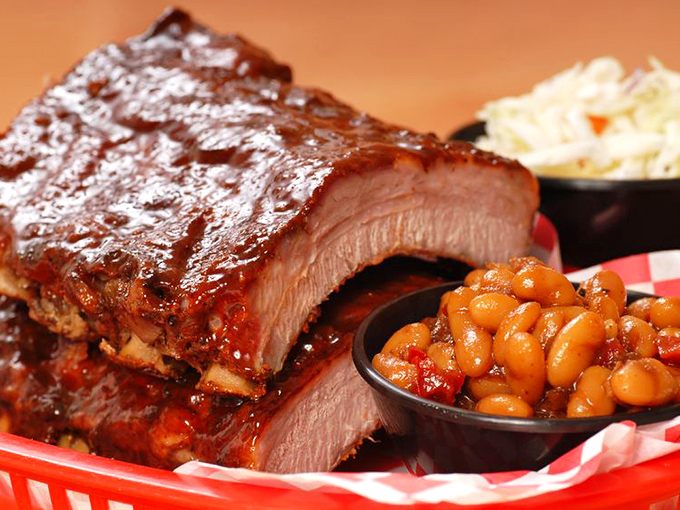 Glistening with sauce and sporting that perfect pink smoke ring, these ribs aren't just food &ndash; they're edible artwork with a side of beans. 