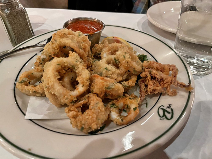 The legendary calamari arrives like a crispy crown jewel, perfectly golden and tender with that sauce that'll haunt your dreams.