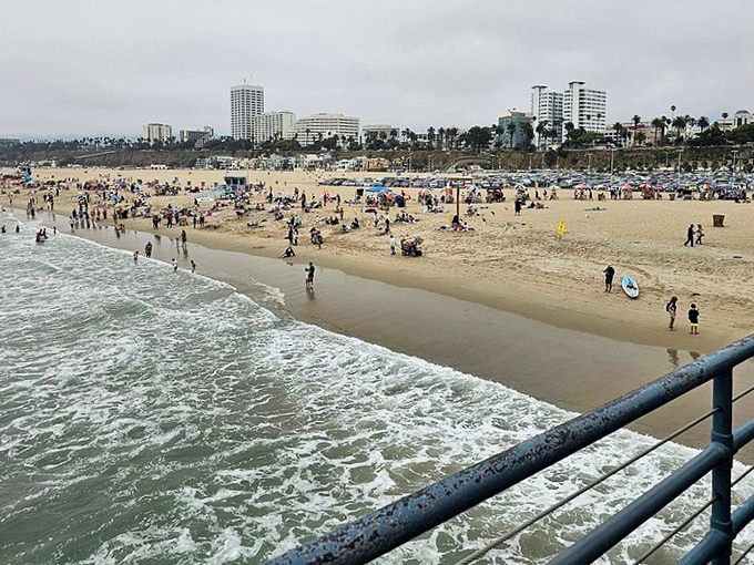 The beach below offers a perfect counterpoint to pier excitement—nature's playground where the Pacific kisses California's golden edge.