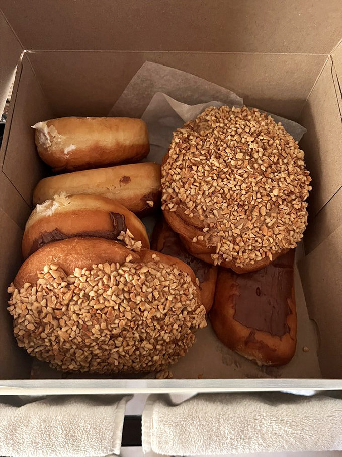Donut nirvana in a humble box. Those peanut-topped beauties have probably launched a thousand cheat days.
