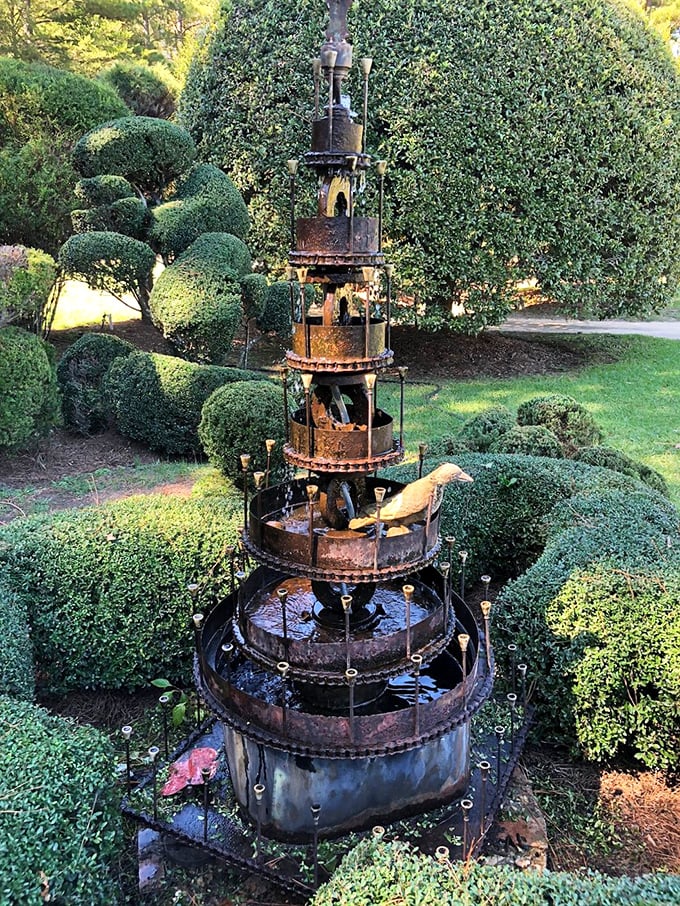 Industrial meets botanical in this multi-tiered water feature. Like a steampunk fantasy come to life, it creates a mesmerizing focal point among the topiaries.