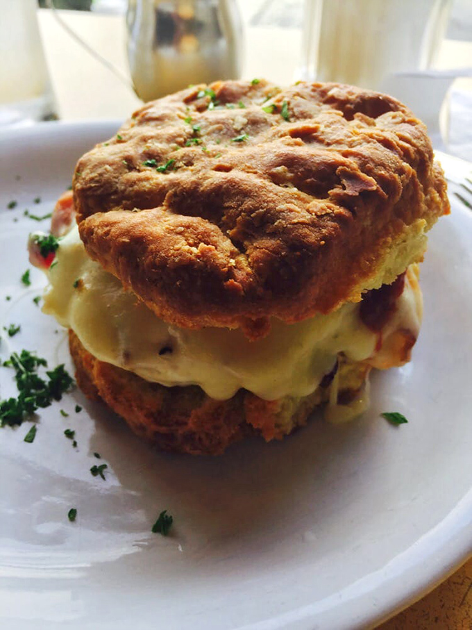This isn't just a biscuit sandwich&mdash;it's a masterpiece of flaky, buttery architecture holding together what might be the world's perfect breakfast.