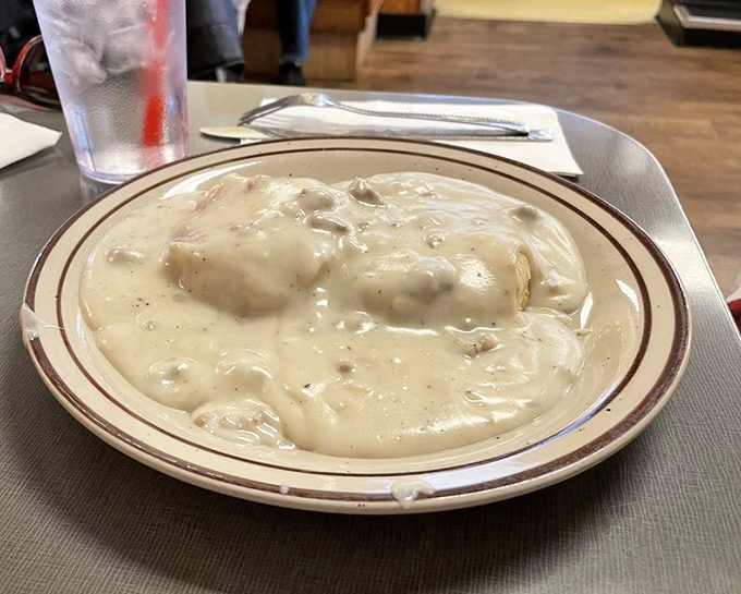 Behold the holy grail of Hoosier breakfast: biscuits drowning in creamy, peppery sausage gravy. This plate has launched a thousand road trips across Indiana.