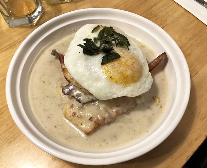 Behold: the biscuit that launched a thousand food pilgrimages. That perfectly poached egg perches atop gravy-soaked heaven like a breakfast crown.