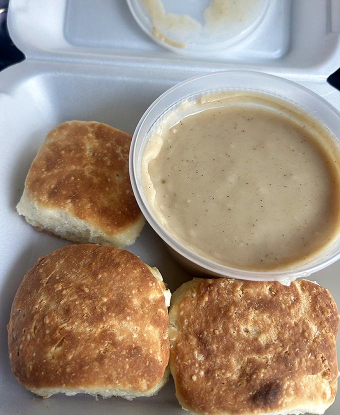 Behold the Southern breakfast royalty: fluffy biscuits drowning in creamy, soul-warming gravy perfection.