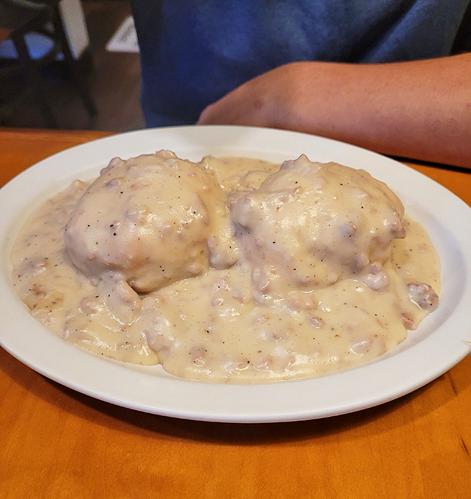Behold the star attraction! These biscuits and gravy aren't just a breakfast—they're a religious experience worth driving across state lines for.