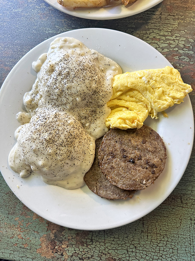 Biscuits swimming in a sea of peppery sausage gravy &ndash; this plate doesn't just feed your hunger, it hugs your soul from the inside.
