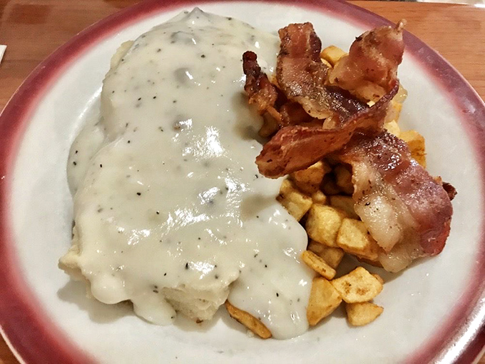 This plate of biscuits and gravy performs the ultimate comfort food magic trick: transforming simple ingredients into a creamy, savory masterpiece that hugs your soul.
