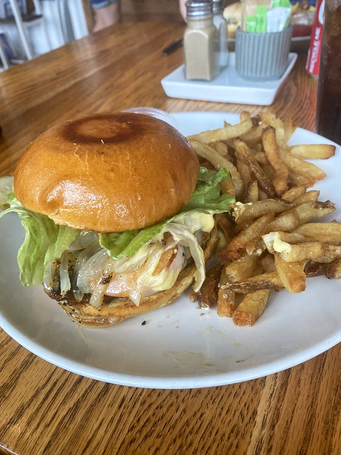 This isn't just any burger&mdash;it's a revelation on a bun. Golden fries stand at attention beside their more famous companion, ready for their supporting role.
