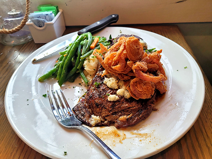 The legendary ribeye in all its glory&mdash;blue cheese crumbles melting into perfectly seared beef with crispy onions standing guard.