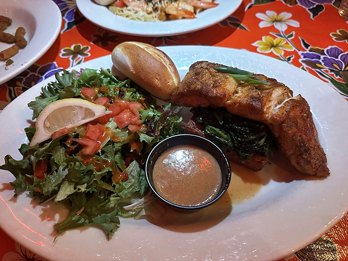 This blackened fish isn't just cooked &ndash; it's been sweet-talked to perfection, nestled alongside fresh greens that provide the perfect counterpoint to that rich butter sauce.