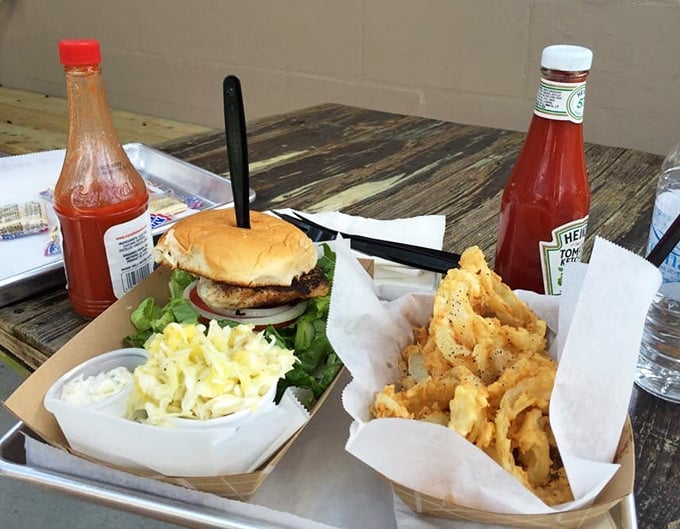 This isn't just a sandwich; it's edible architecture. The blackened grouper, coleslaw, and those golden onion straws create the Taj Mahal of seafood experiences.