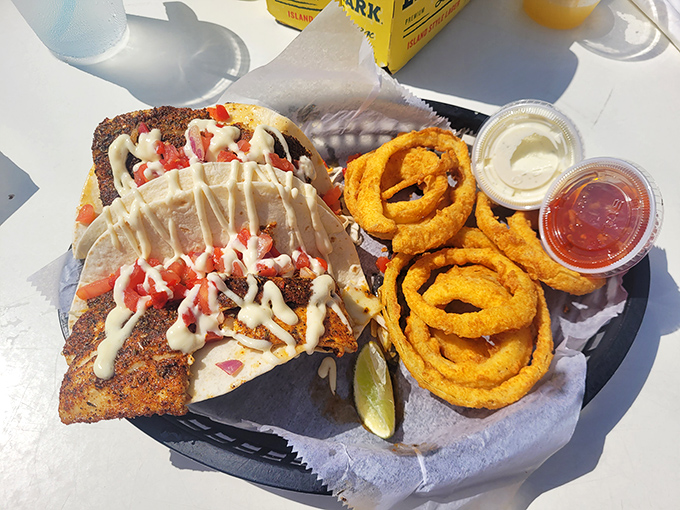 Blackened mahi tacos arrive like edible sunshine, perfectly spiced and topped with tropical perfection.