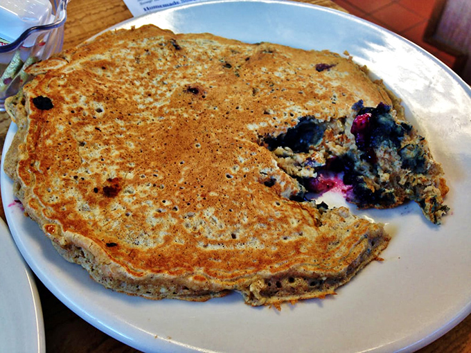 This blueberry pancake isn't trying to win Instagram—it's trying to win your heart with bursts of berry goodness and perfectly crisp edges.