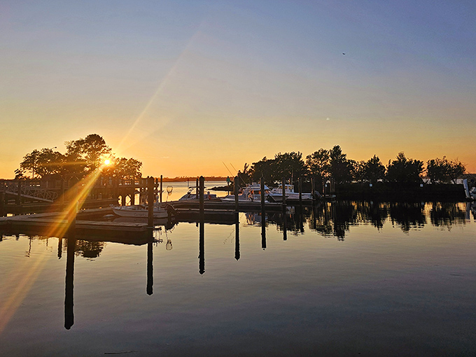 Twilight magic at the marina, where boats rest after a day's adventure and reflections double the beauty of sunset's golden hour.