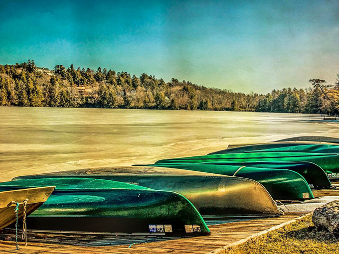Winter transforms Eagles Mere Lake into a serene landscape of ice and solitude, with upturned canoes patiently awaiting summer's return like hibernating creatures.