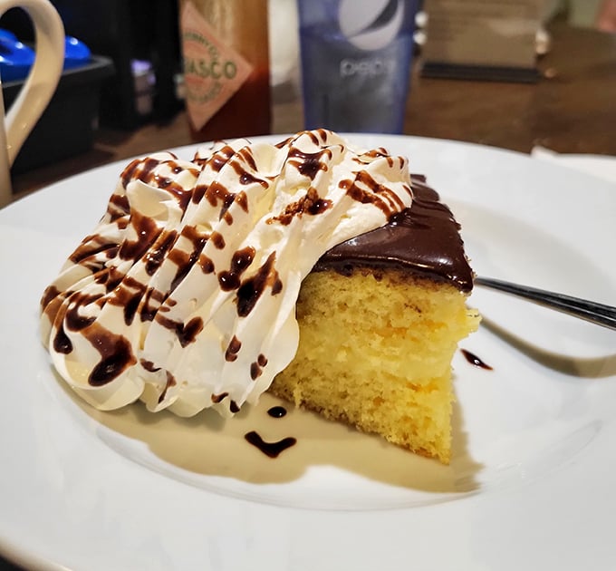 This Boston Cream Pie isn't just dessert, it's therapy on a plate &ndash; golden cake, chocolate ganache, and whipped cream drizzled with chocolate that would make a pastry chef weep.