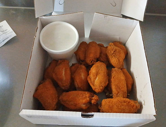 Golden-brown perfection in a humble white box. These wings aren't trying to impress you with fancy sauces&mdash;they don't need to.