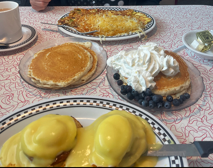 Breakfast nirvana achieved! Golden pancakes, blueberry stacks crowned with whipped cream, eggs Benedict, and an omelet that could feed a small town.