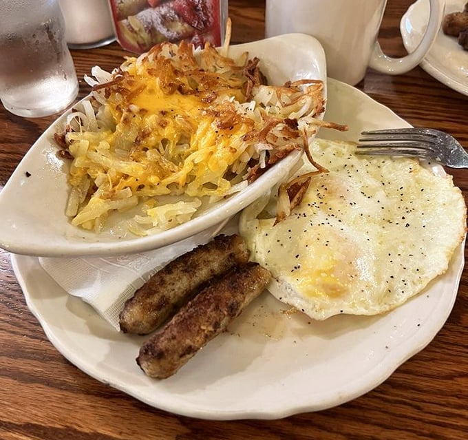 Breakfast harmony achieved: crispy hash browns, perfectly cooked eggs, and sausage links that snap with each bite.