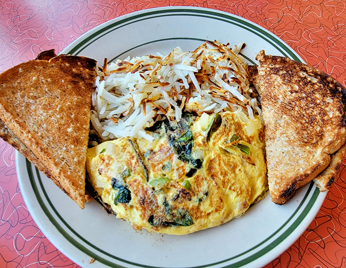 Behold the omelet that could make a grown person weep tears of pure breakfast joy.