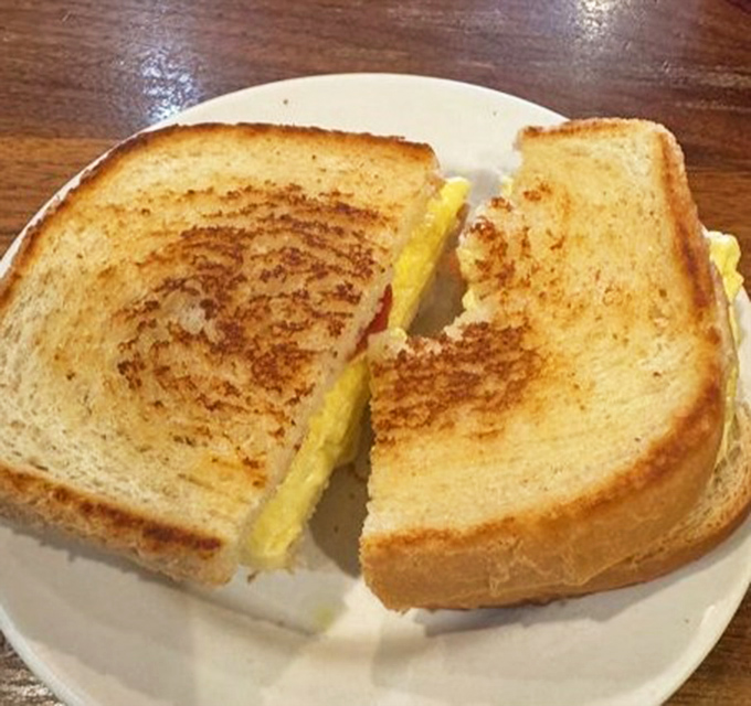 Golden-brown toast embracing fluffy eggs and melted cheese&mdash;this breakfast sandwich isn't just good, it's the reason alarm clocks were invented.