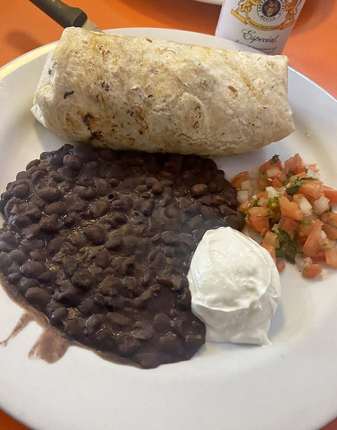 This breakfast burrito isn't just a meal, it's a commitment&mdash;black beans, sour cream, and pico de gallo creating a morning fiesta on a plate.