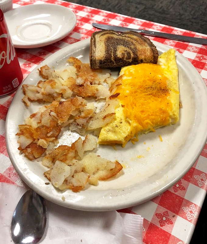 Breakfast perfection on a plate: golden hash browns with just the right crispiness, a fluffy cheese omelet, and toast that somehow tastes better than the bread you buy.
