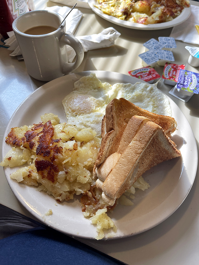 Breakfast fundamentals executed perfectly: crispy-edged eggs, golden home fries, and toast that's actually toasted. The Holy Trinity of diner breakfasts.