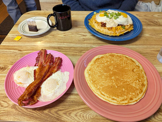 Golden pancakes with that perfect crisp edge, scrambled eggs, and bacon that would make even a vegetarian question their life choices.