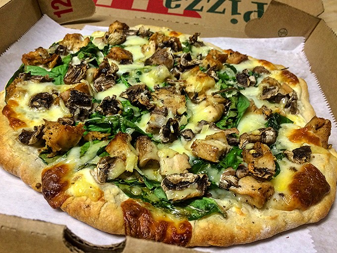 Pizza perfection achieved! This mushroom and spinach masterpiece sports a crust with that magical brick-oven char&mdash;crispy exterior, chewy interior&mdash;that pizza dreams are made of.