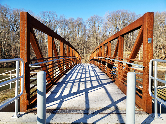 The rust-colored bridge isn't just functional &ndash; it's a portal between everyday worries and the simple joy of being surrounded by nature.