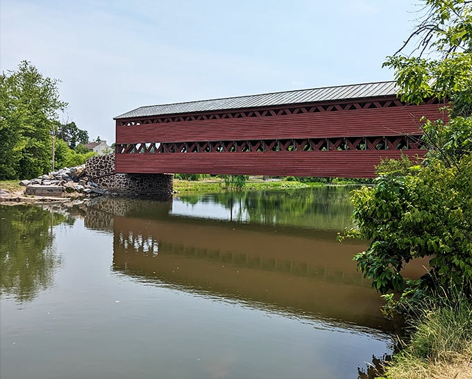 The latticed sides of the bridge create a mesmerizing play of light and shadow on the water below.
