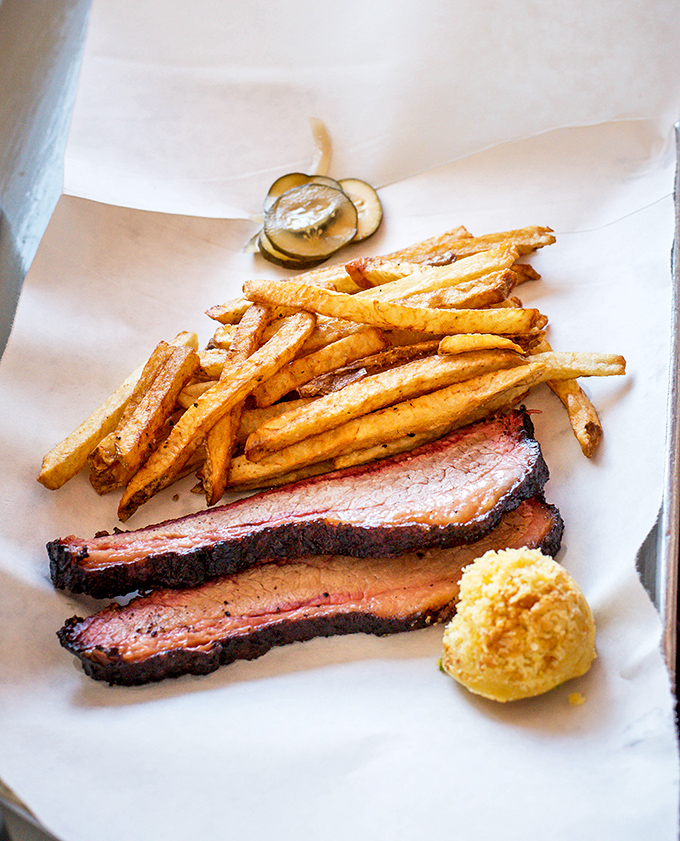 Brisket slices with that telltale pink smoke ring and hand-cut fries. This isn't just lunch; it's edible art with a side of comfort.