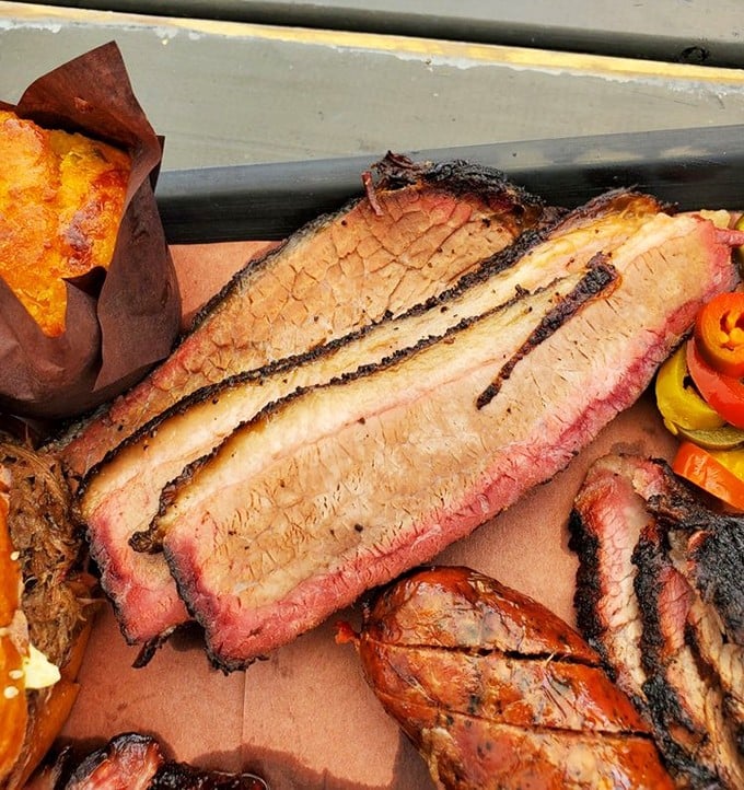 Behold the brisket—that bark, that smoke ring, that glistening fat. This isn't just meat; it's a time-traveling device to Texas.
