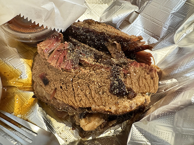 Brisket with a bark so perfect it should be in a museum. That pink smoke ring isn't just pretty—it's a diploma from Barbecue University.
