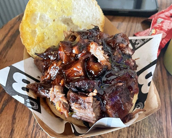 Behold: meat architecture at its finest. This brisket sandwich doesn't just satisfy hunger&mdash;it creates memories. The bread is merely a delivery system for smoky perfection.