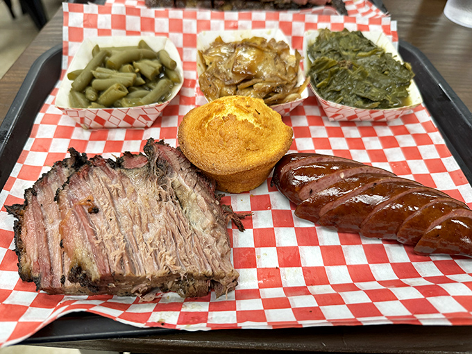 BBQ perfection on a red checkered canvas&mdash;brisket with that coveted smoke ring alongside sausage and sides that don't know the meaning of "afterthought."